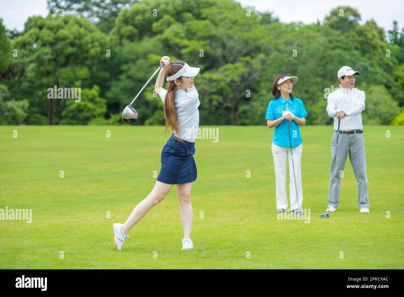 Family of three playing golf Stock Photo - Alamy