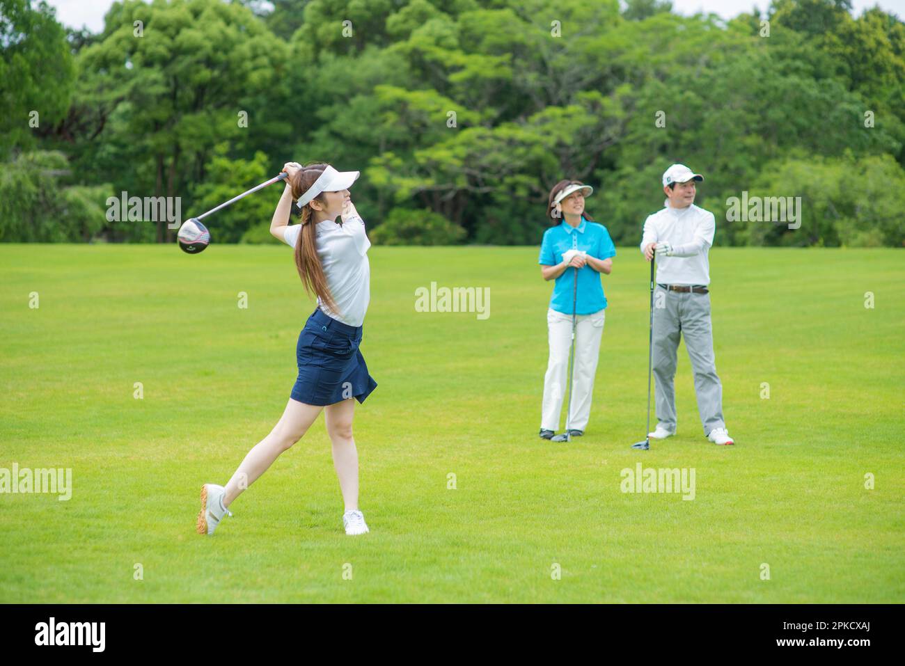 A family of three playing golf Stock Photo - Alamy