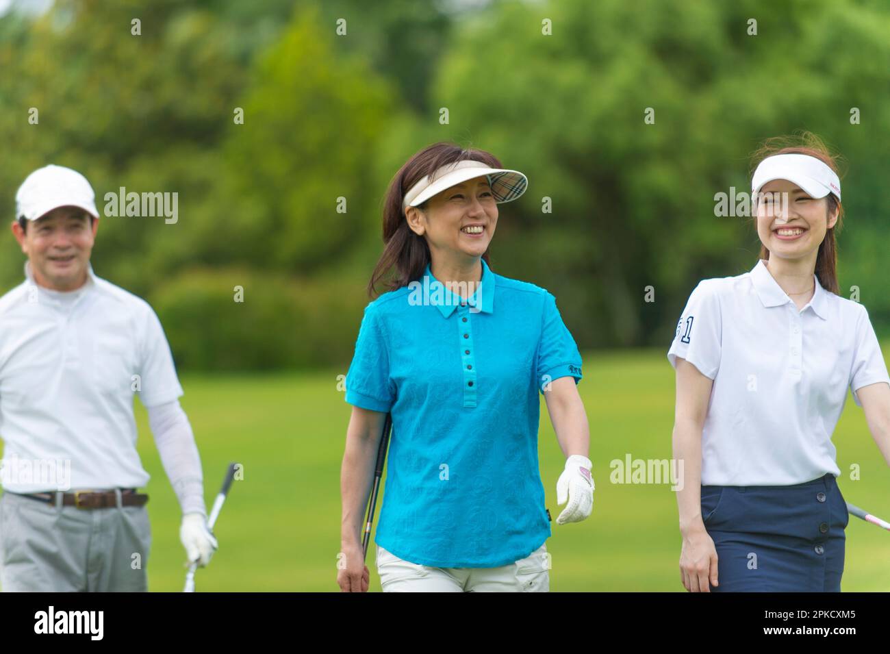 Family of three playing golf Stock Photo - Alamy