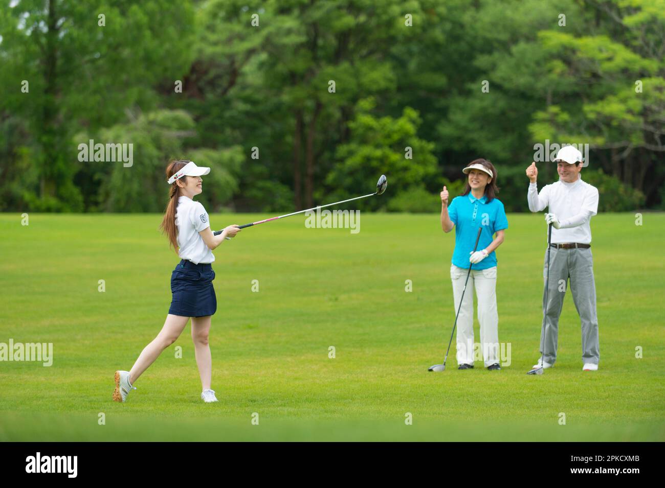 Family of three playing golf Stock Photo - Alamy