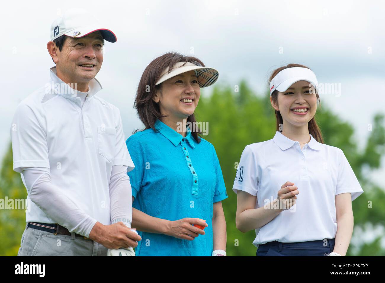 Family of three playing golf Stock Photo - Alamy