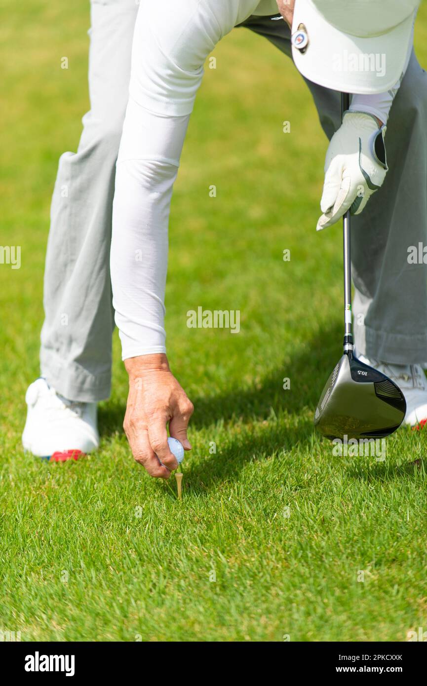 A middle-aged man playing golf Stock Photo - Alamy