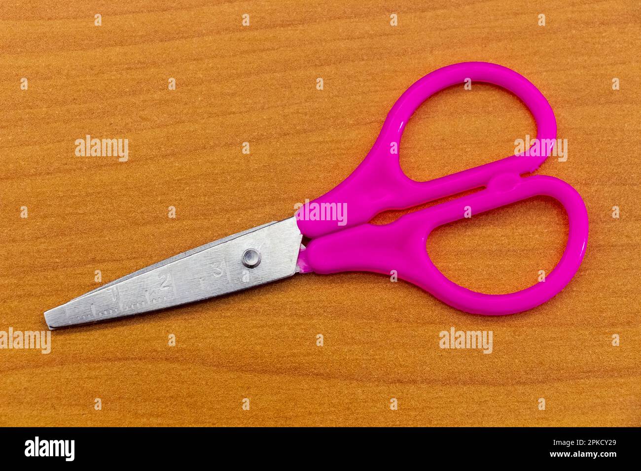 Purple stationery scissors on the surface of the office table Stock ...