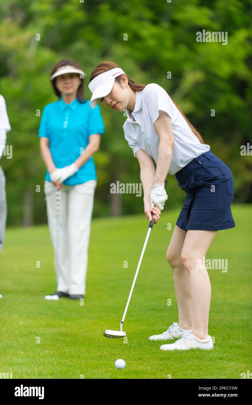 Mother and Daughter Playing Golf Stock Photo - Alamy