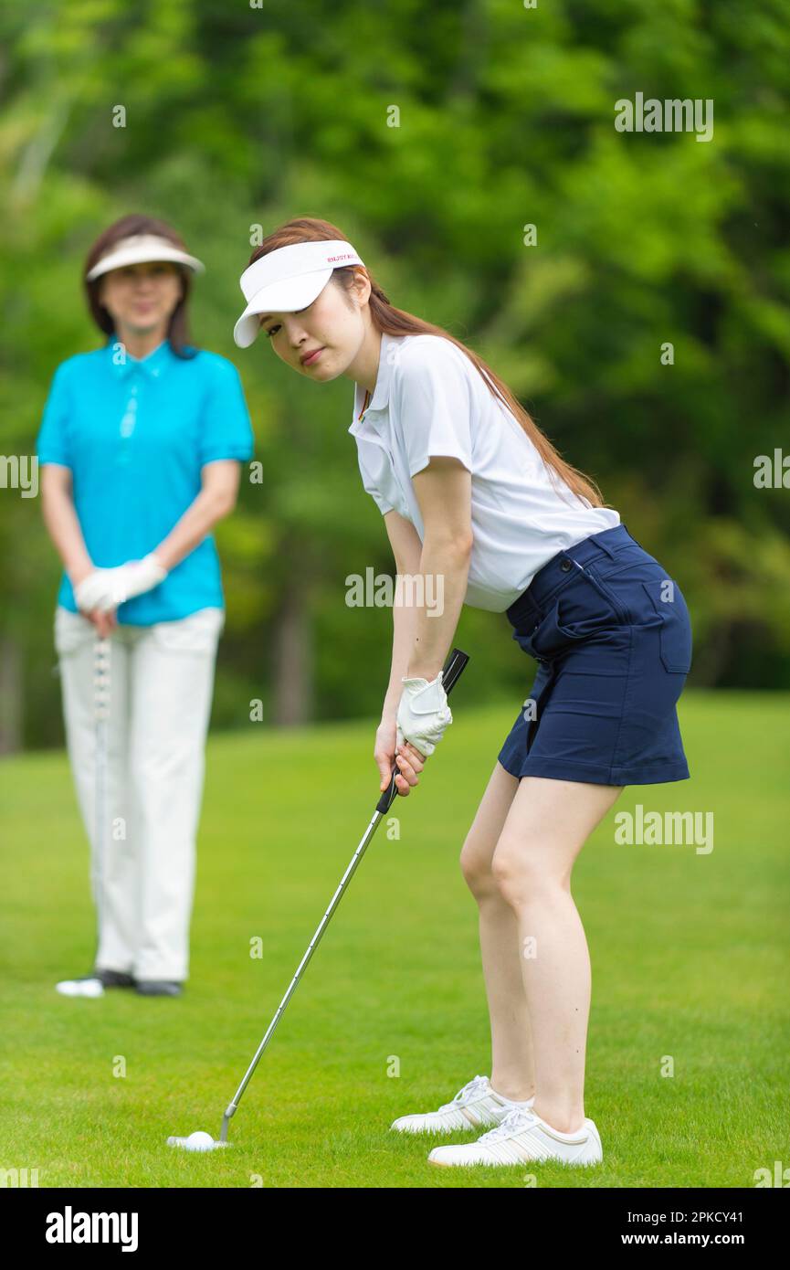 Mother and Daughter Playing Golf Stock Photo - Alamy