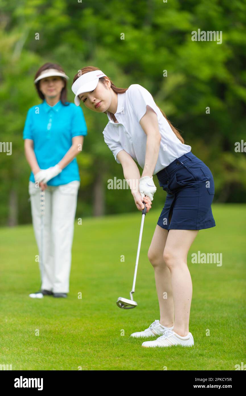 Mother and Daughter Playing Golf Stock Photo - Alamy