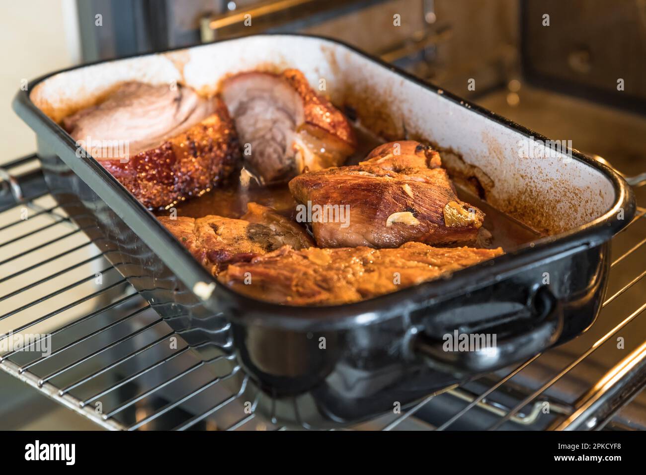 Real hearty homemade roast pork in a roaster casserole in the oven ...