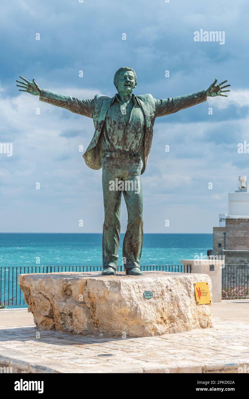 Bronze statue of the Italian singer Domenico Modugno facing the old ...