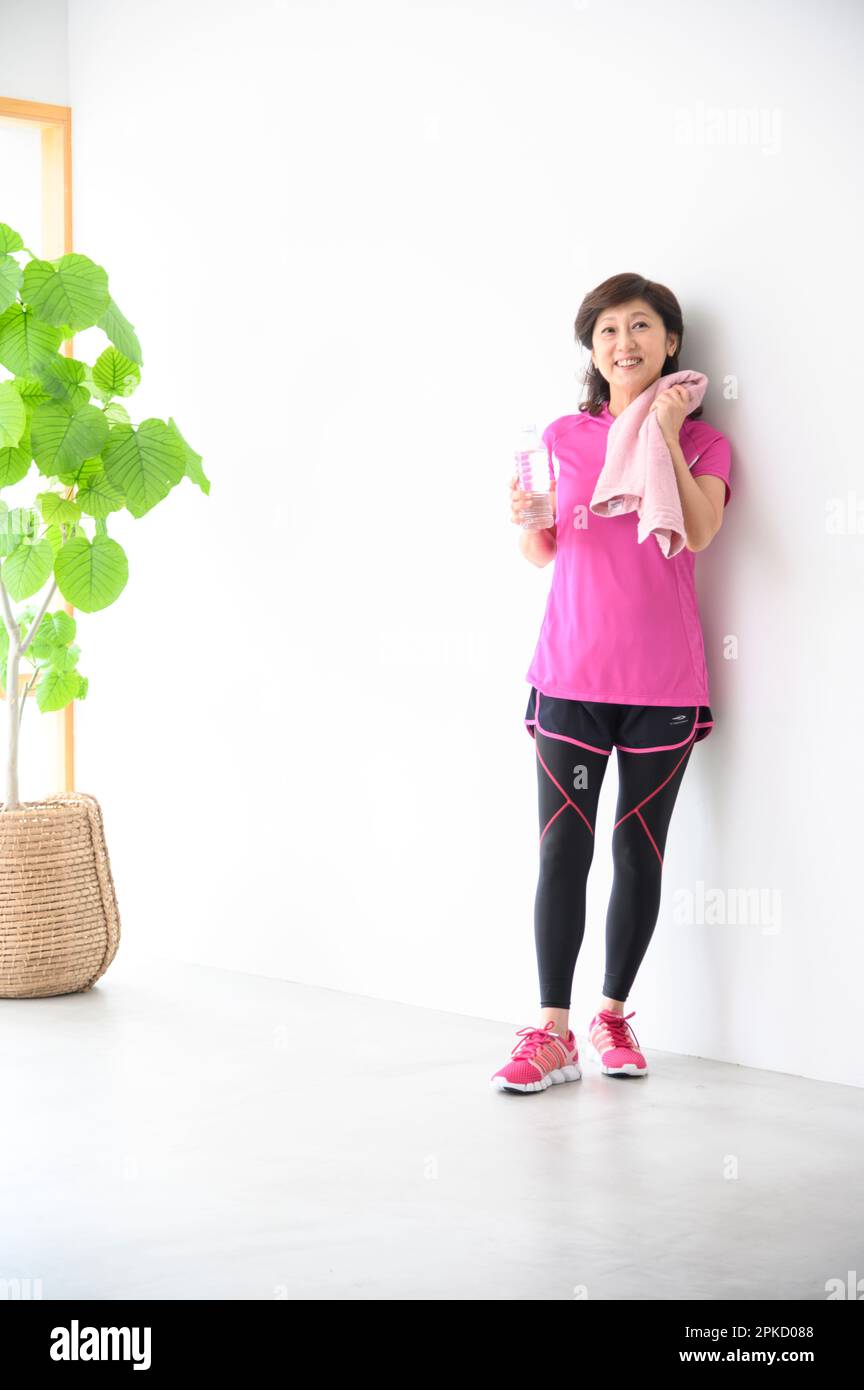 Middle-aged women who take a rest after exercise Stock Photo - Alamy