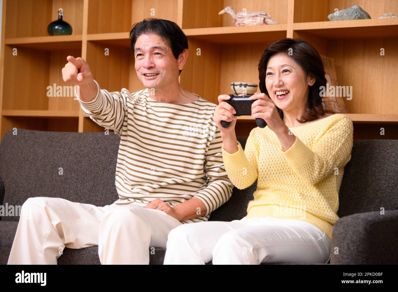 Middle-aged couple playing a video game Stock Photo - Alamy
