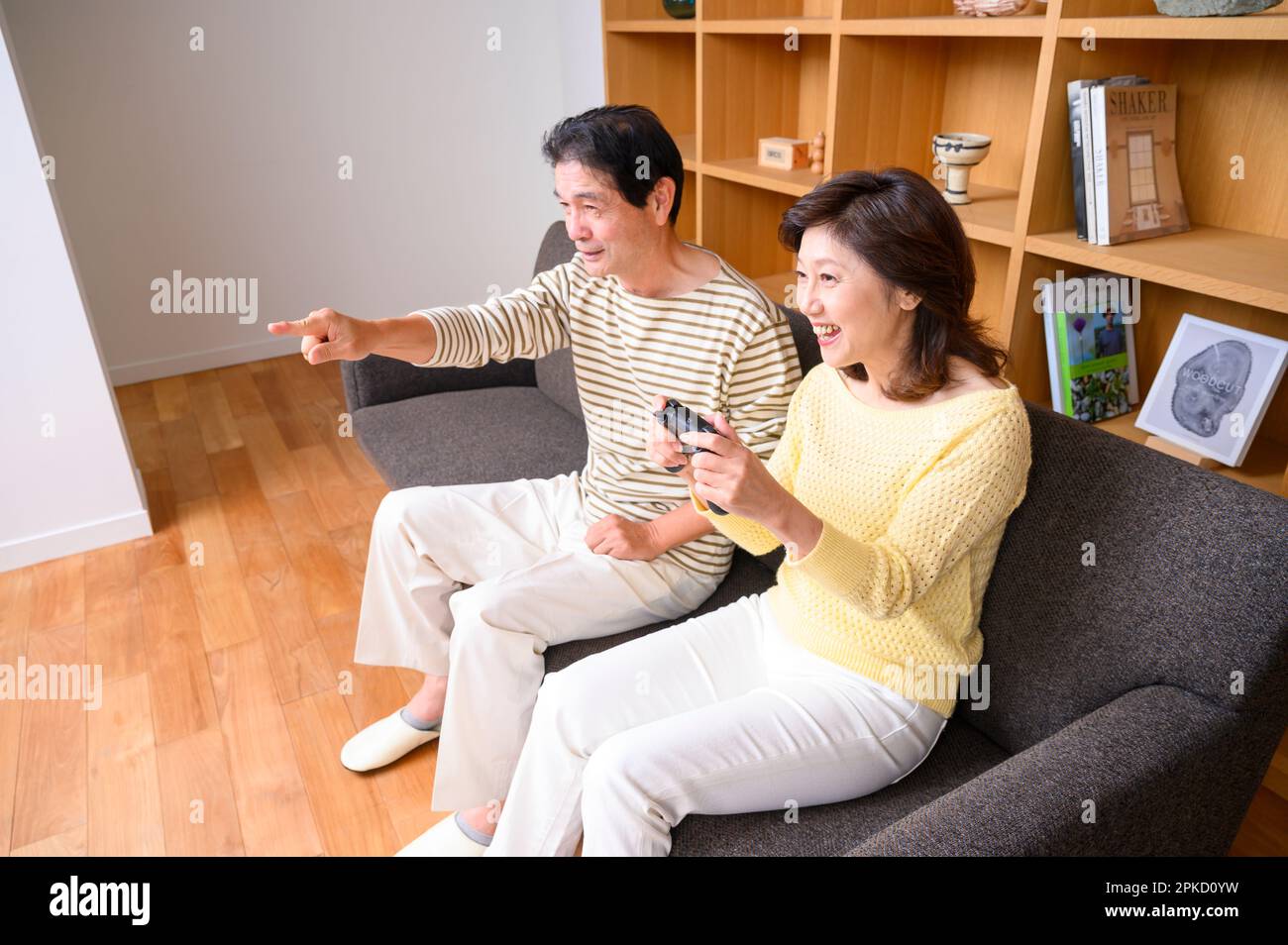 A middle-aged couple playing video games Stock Photo - Alamy