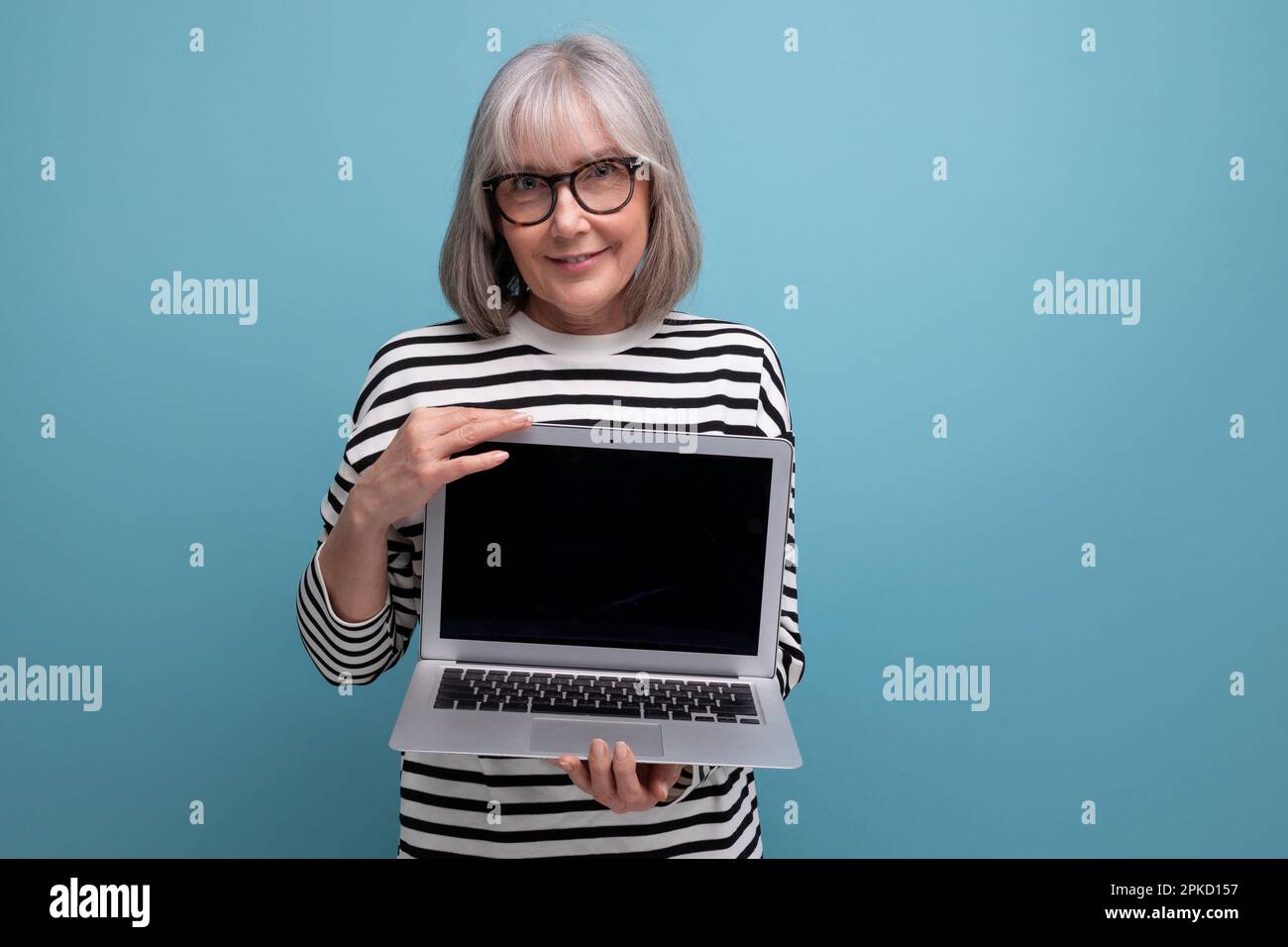 modern middle aged woman holding pc with advertising mockup on bright ...