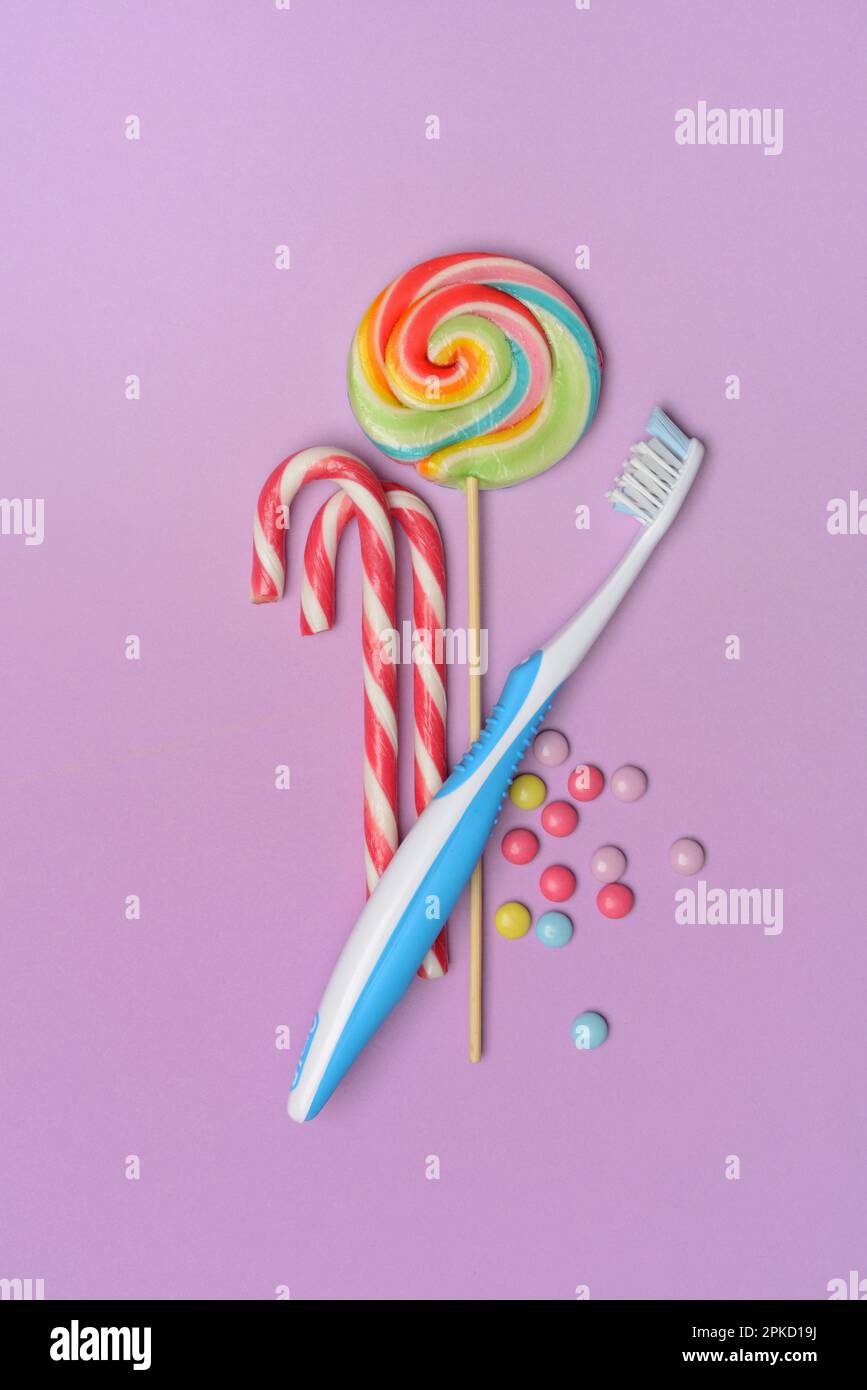 Candy canes, lollipops and toothbrush, dental hygiene Stock Photo - Alamy
