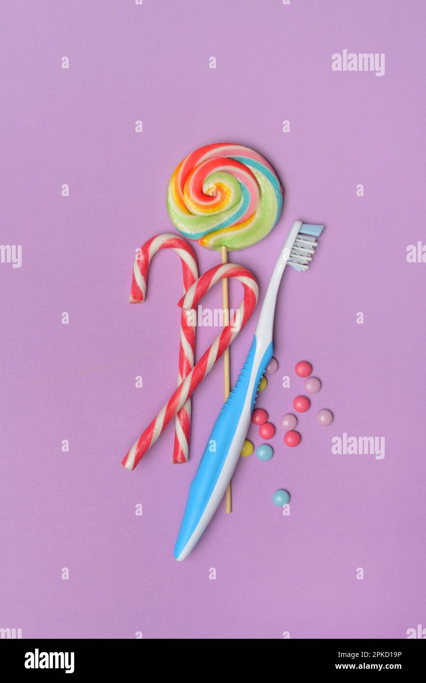Candy canes, lollipops and toothbrush, dental hygiene Stock Photo - Alamy