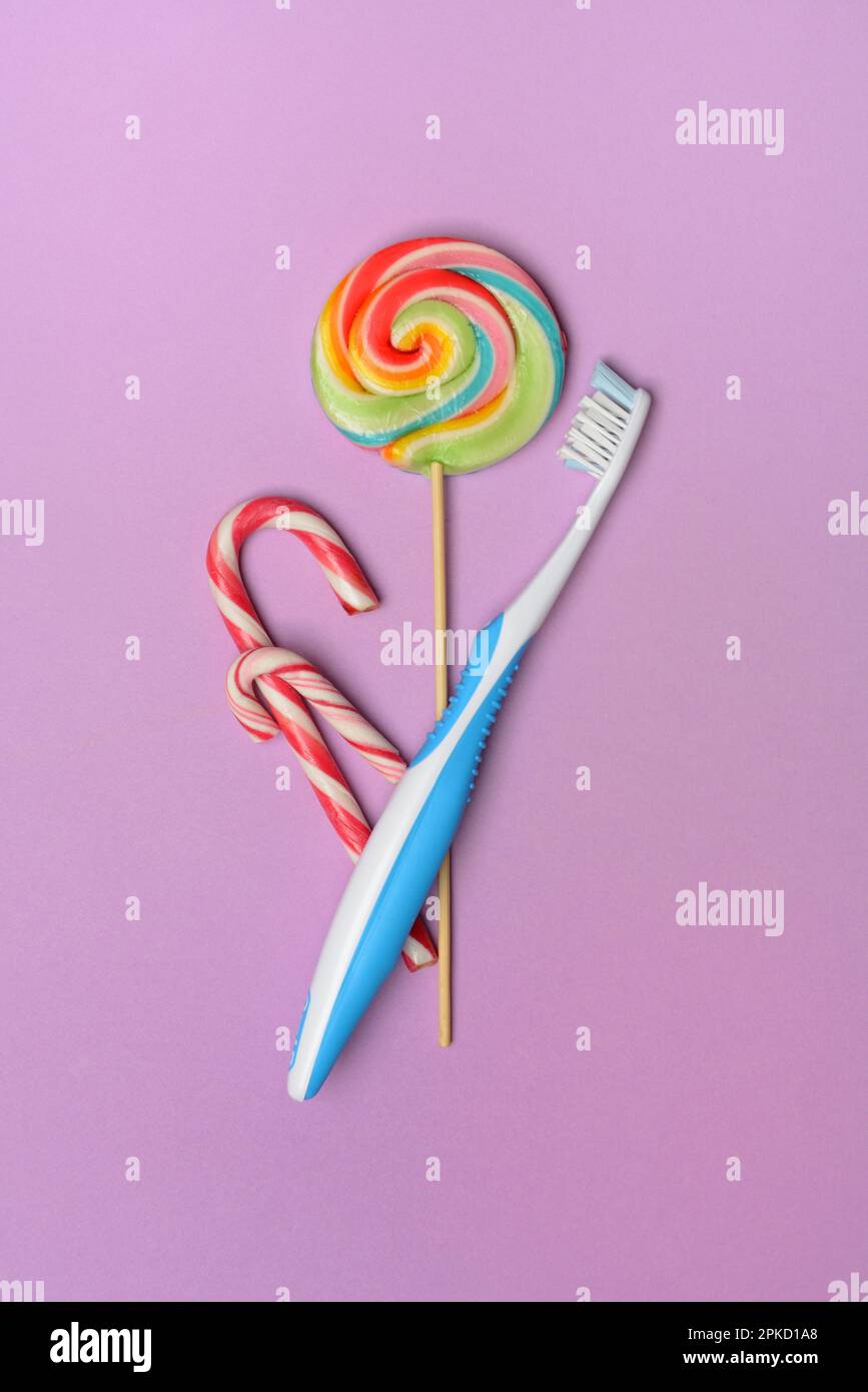 Candy canes, lollipops and toothbrush, dental hygiene Stock Photo - Alamy