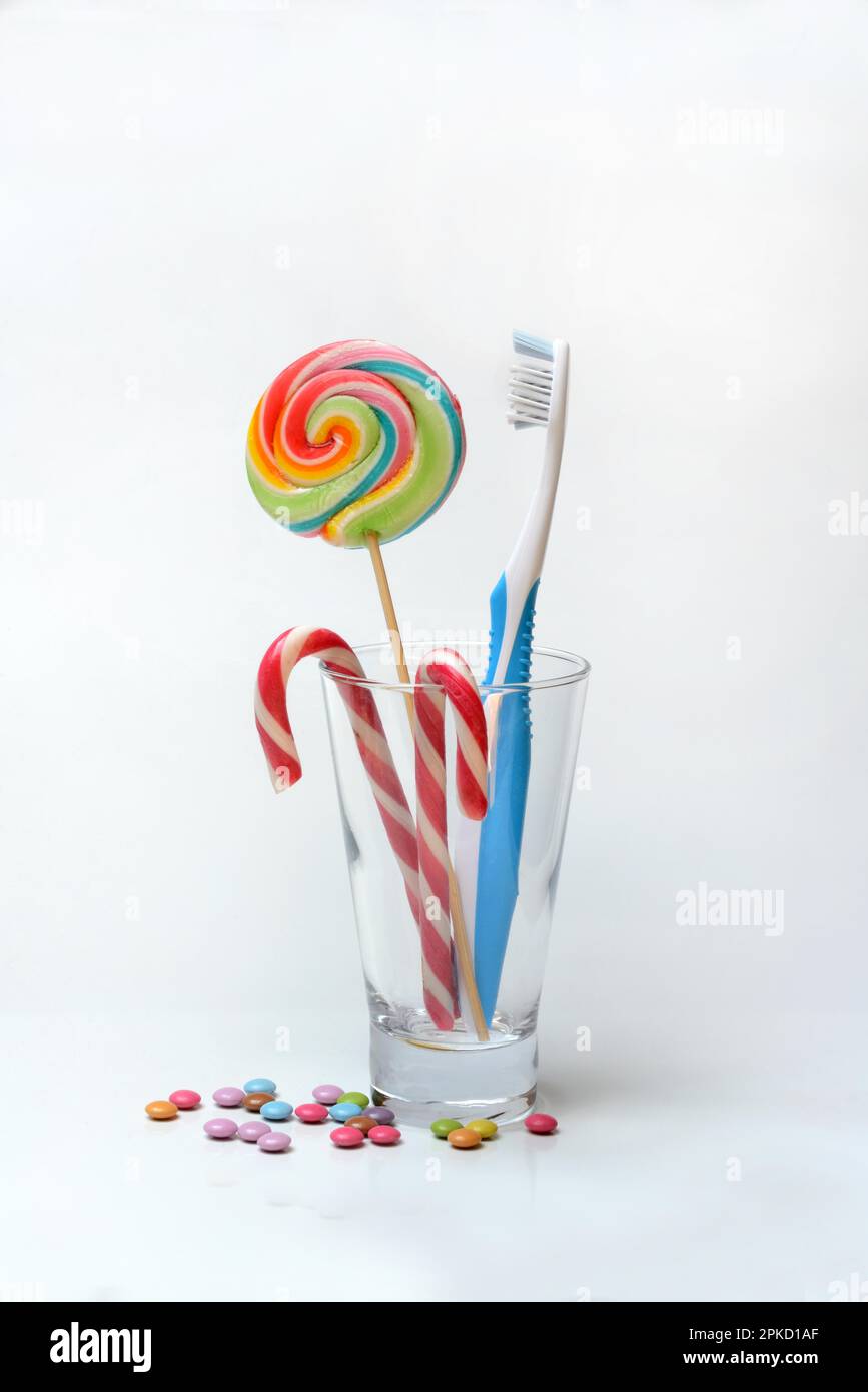 Candy canes, lollipops and toothbrush in glass, dental hygiene Stock ...