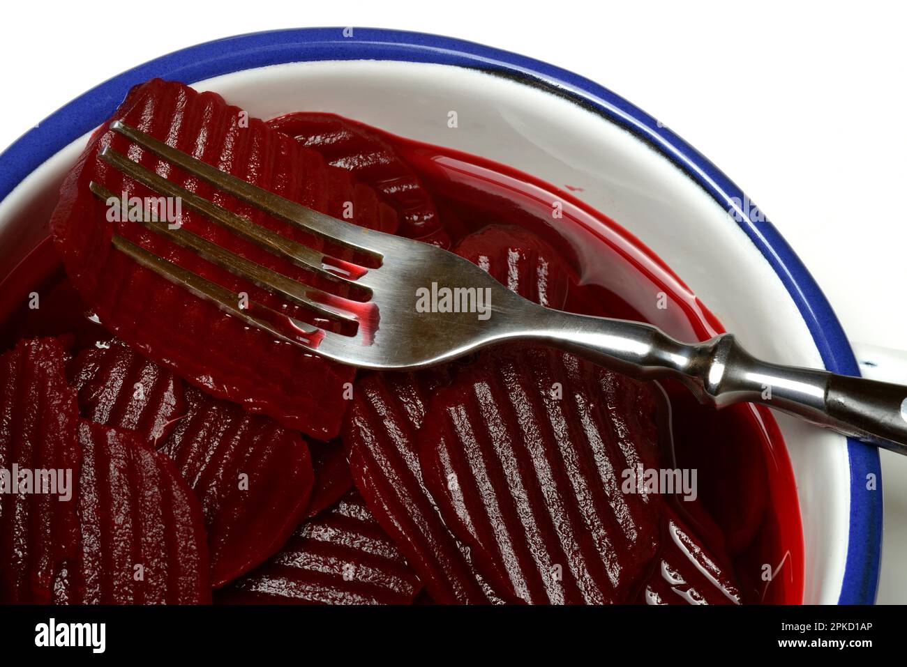 Sliced pickled beetroot with peel and fork, Beta vulgaris Stock Photo ...