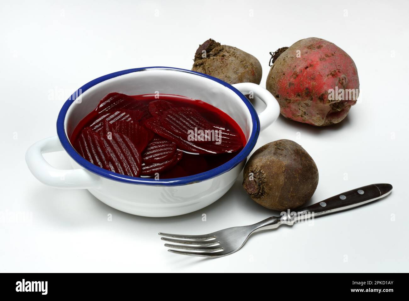 Sliced pickled beetroot with peel and fork, Beta vulgaris Stock Photo ...