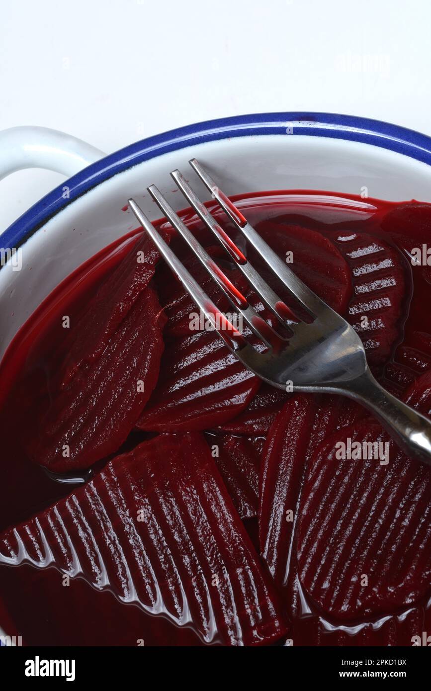 Sliced pickled beetroot with peel and fork, Beta vulgaris Stock Photo ...