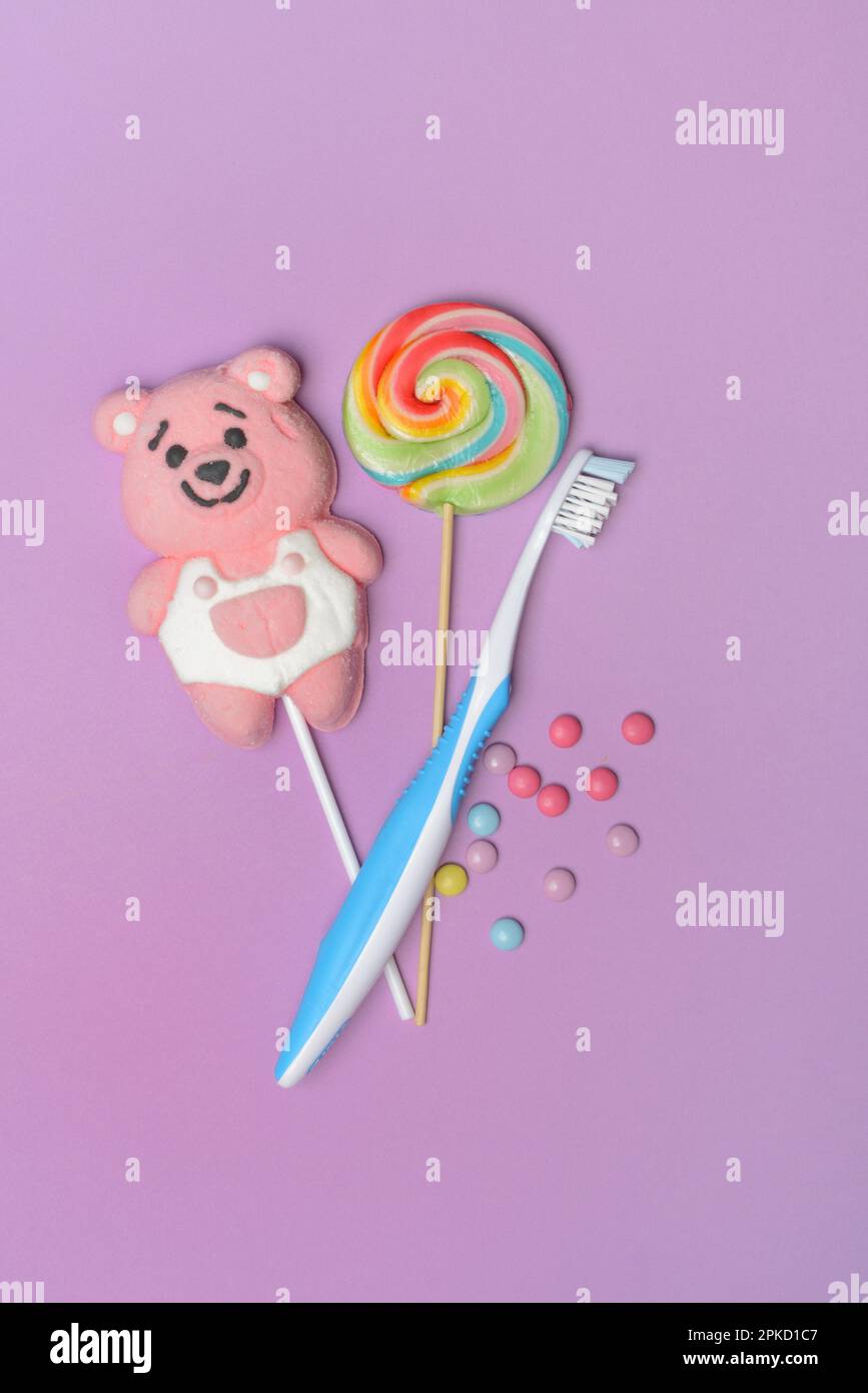 Candy canes, lollipops and toothbrush, dental hygiene Stock Photo - Alamy