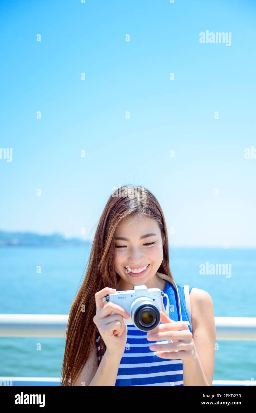 woman traveling to the resort taking pictures on the bridge over the ...