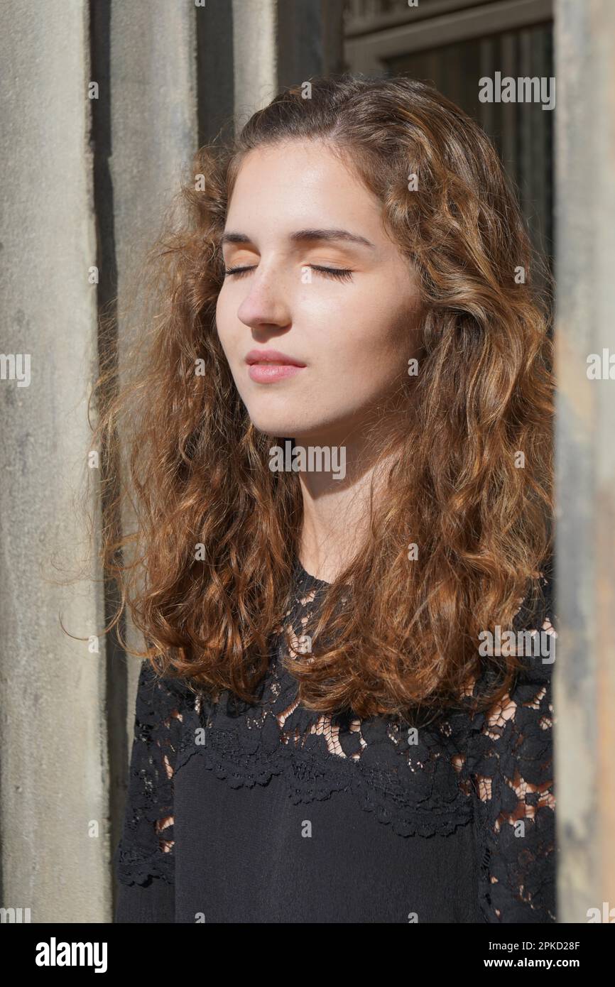 young woman enjoying the sunshine on her face Stock Photo - Alamy