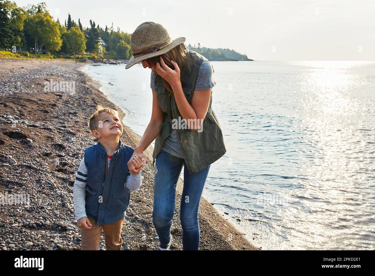 Are you having fun yet. a young woman and her son enjoying a walk by ...