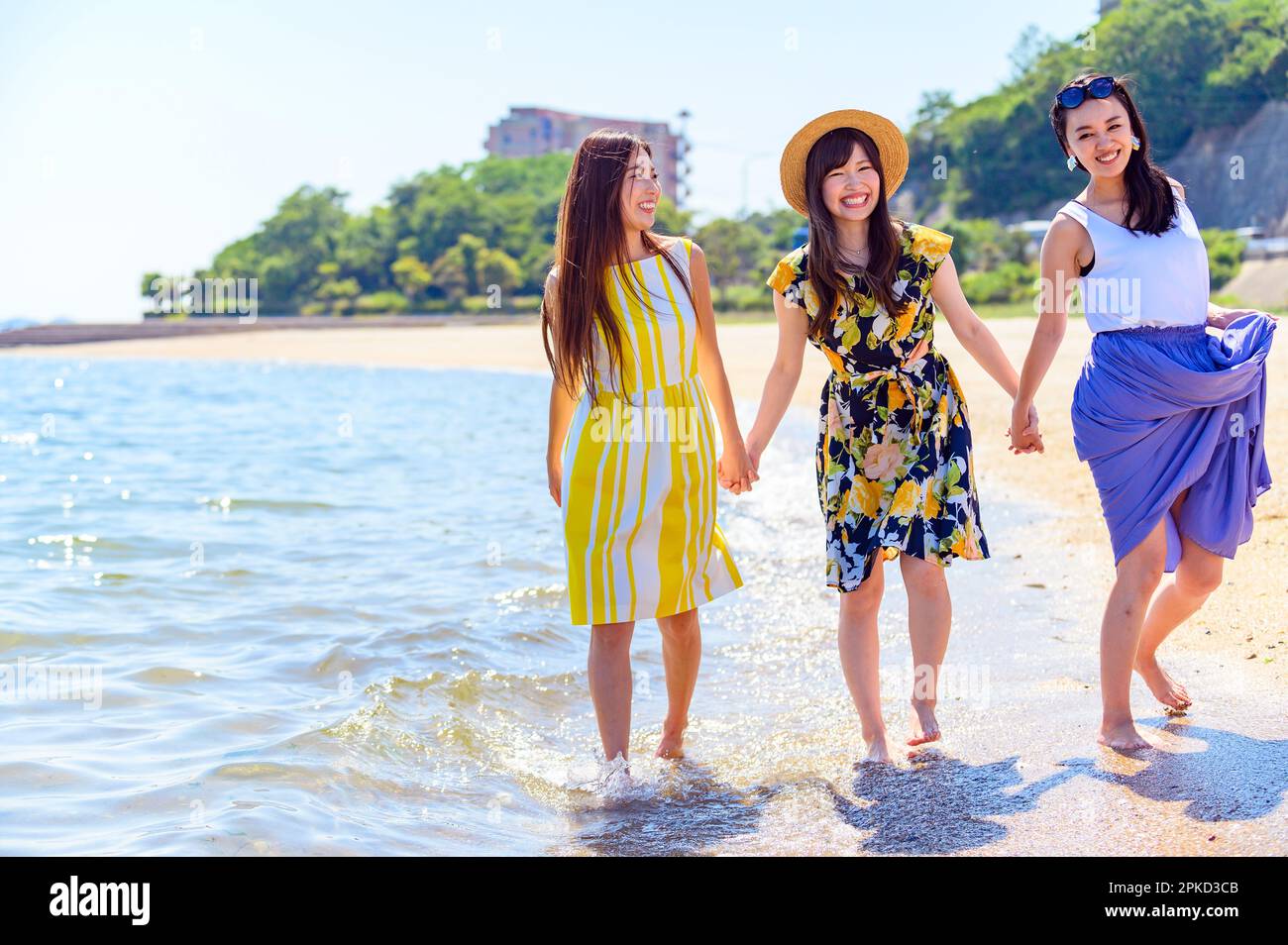 3 women traveling to a sea resort playing on the beach Stock Photo - Alamy