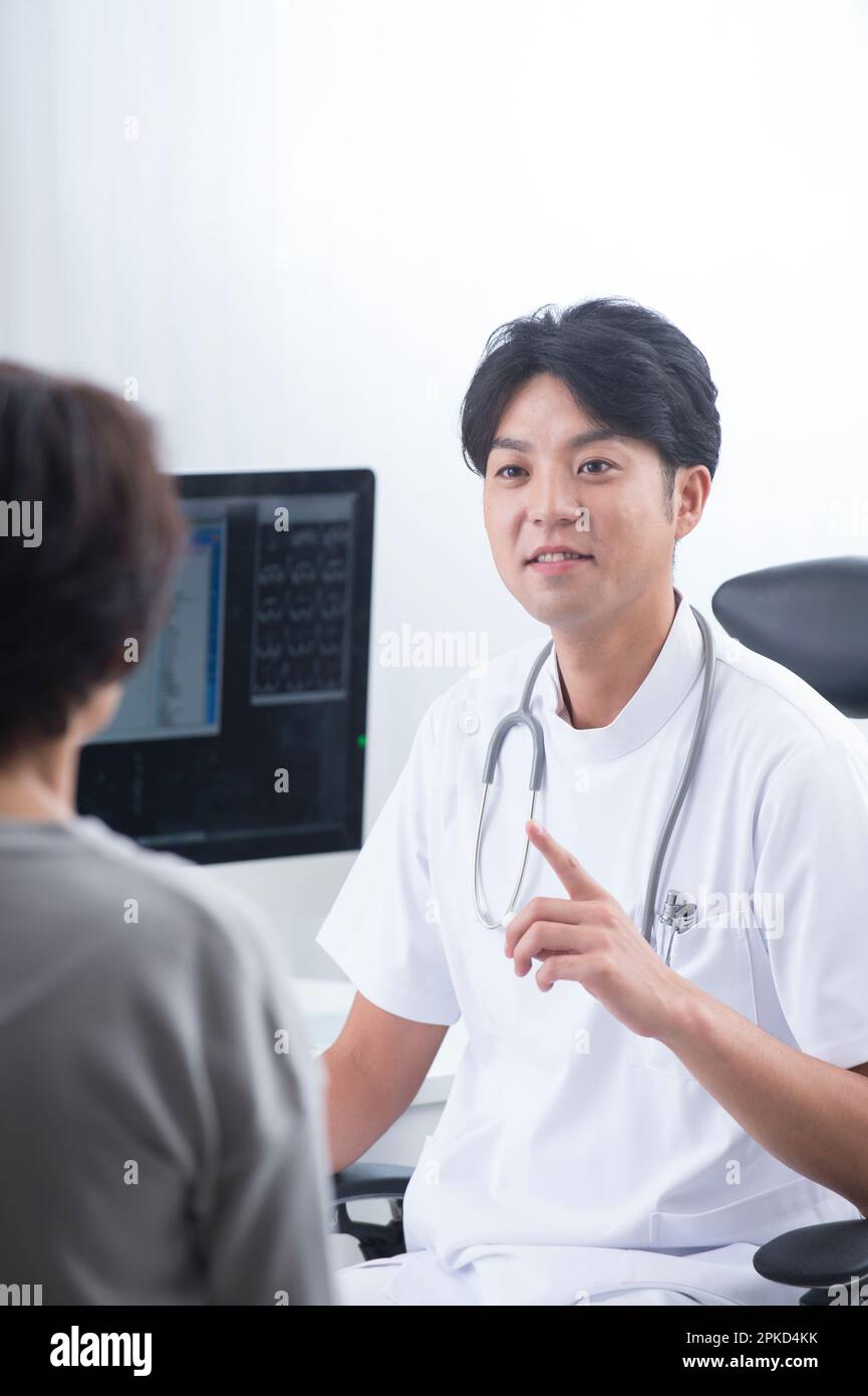 Doctor examining a patient Stock Photo - Alamy