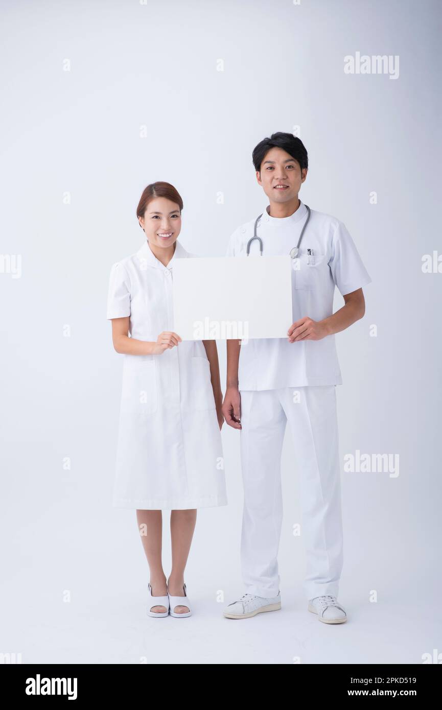 Doctor and nurse with message board Stock Photo - Alamy
