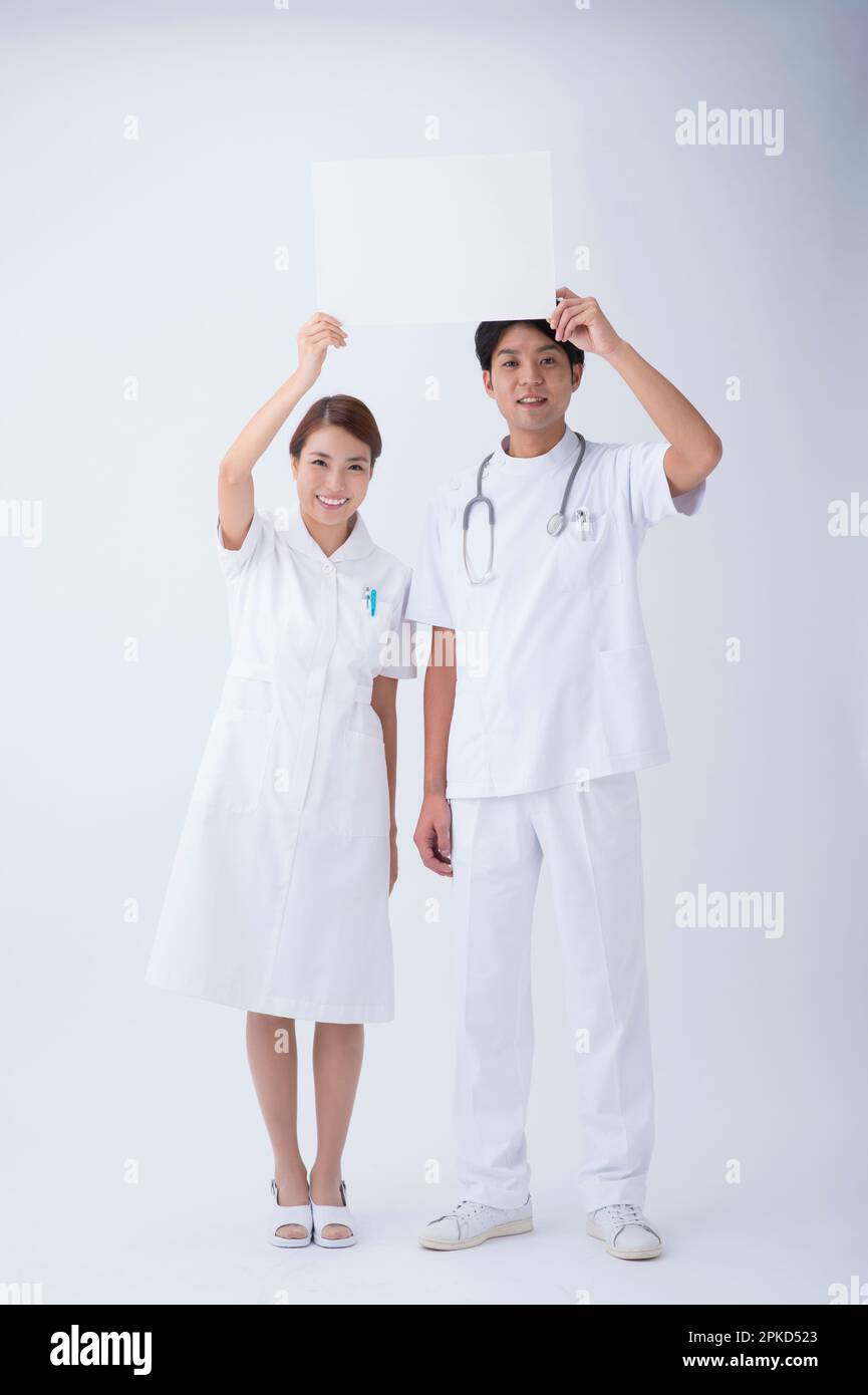 Doctor and nurse with message board Stock Photo - Alamy