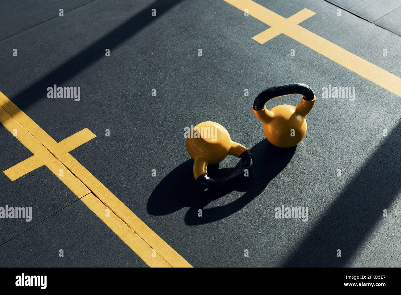 Weights painted in yellow color laying down on the ground in the gym ...
