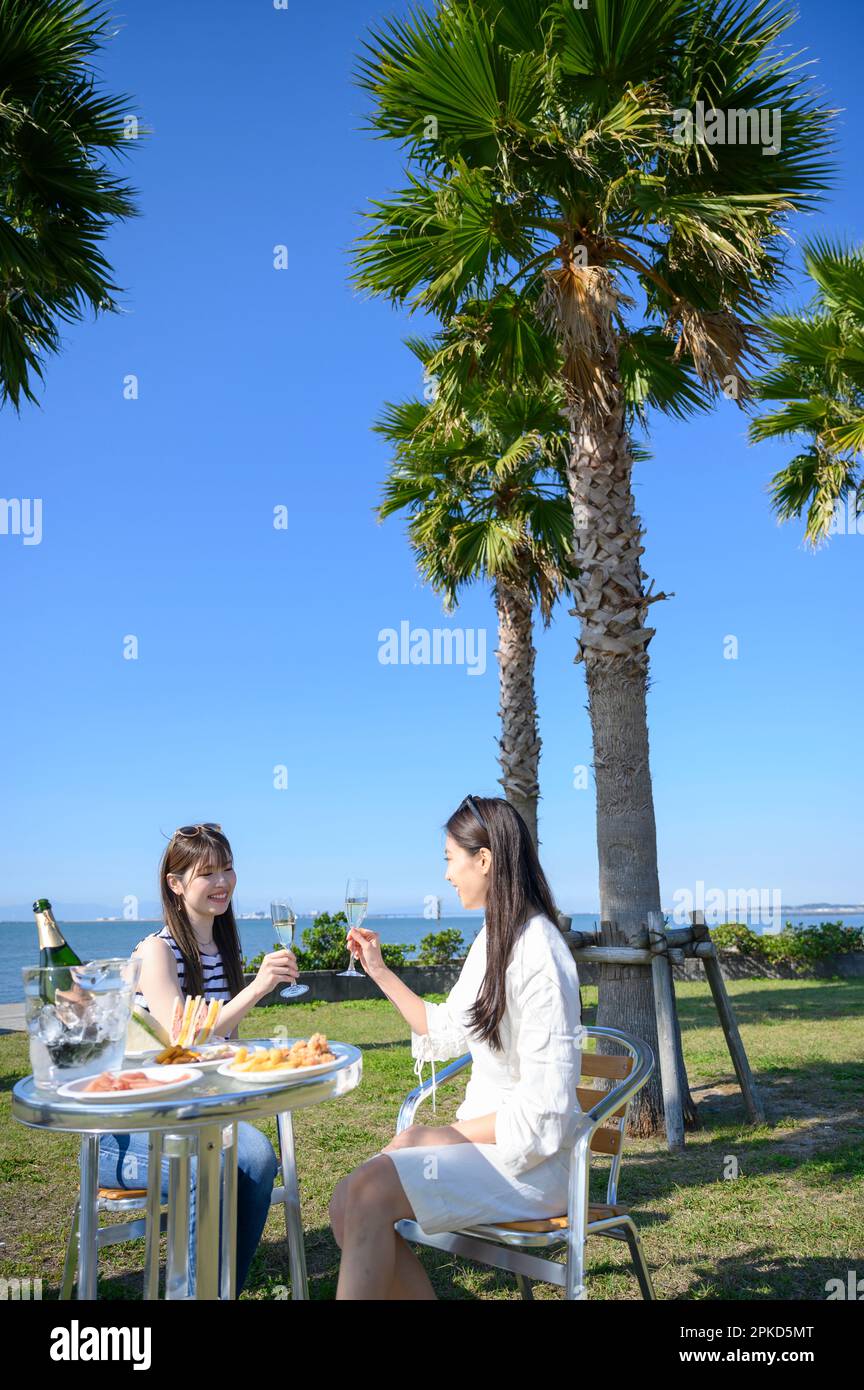 Two women dining at a sea resort Stock Photo - Alamy