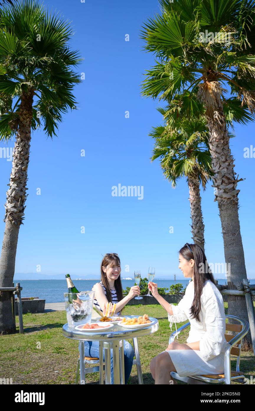 2 women dining in a sea resort Stock Photo - Alamy