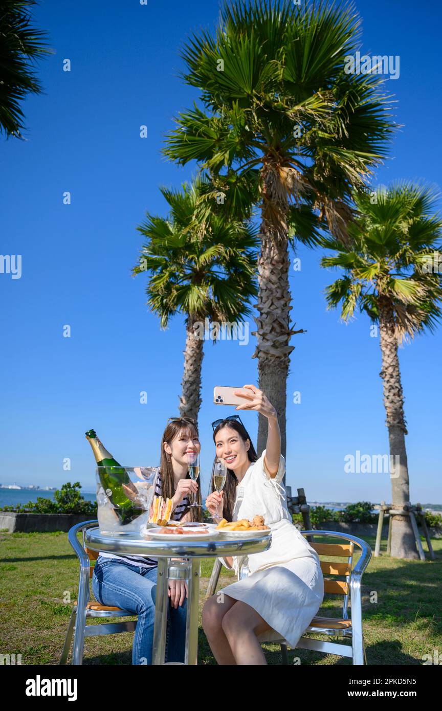 2 women dining in a sea resort Stock Photo - Alamy