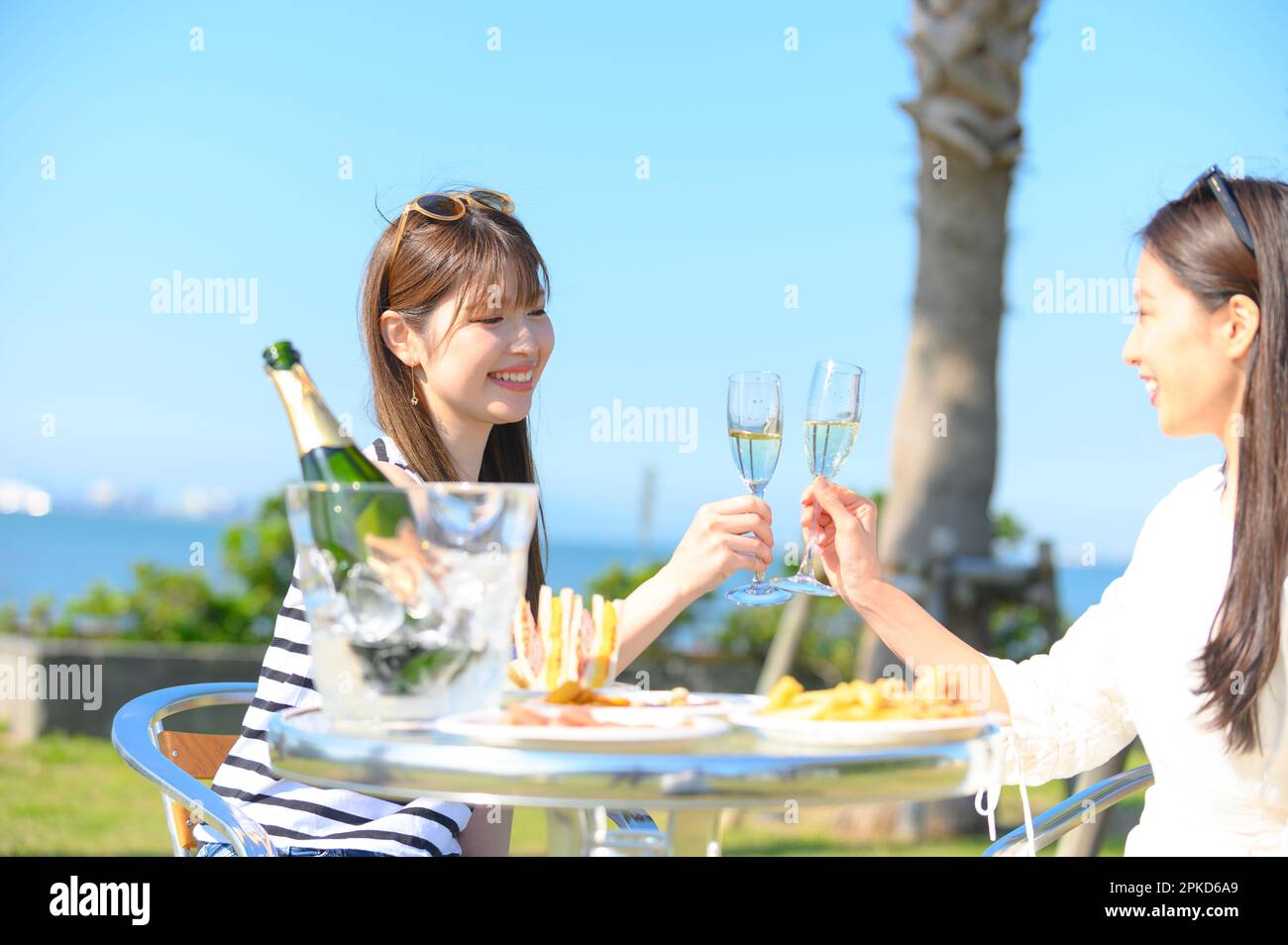 Two women dining at a sea resort Stock Photo - Alamy