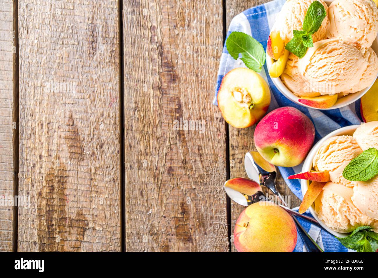 Homemade sweet peach ice cream. Peach gelato balls in small bowls, on ...