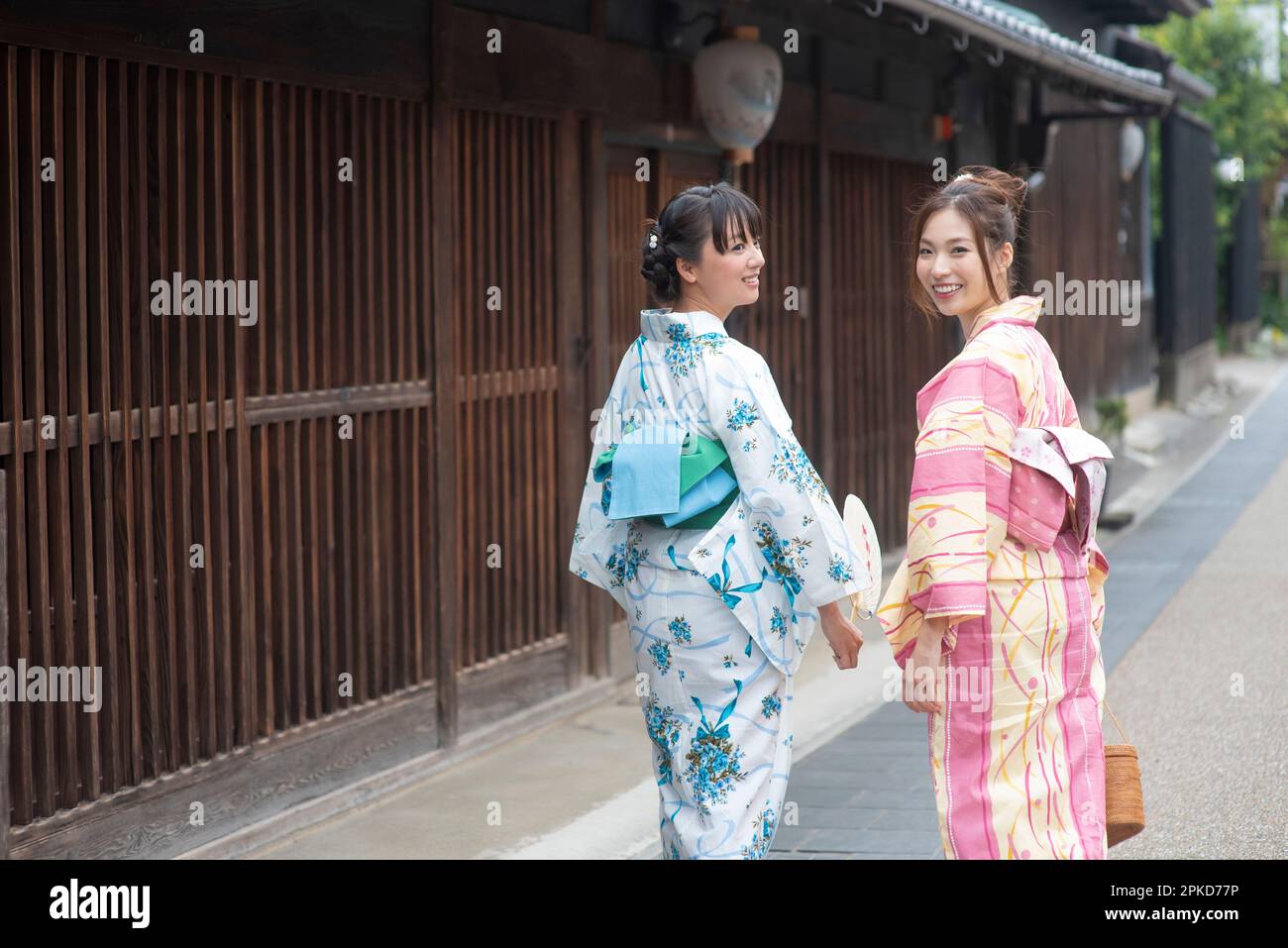 Two women in yukata strolling in an old private house Stock Photo - Alamy