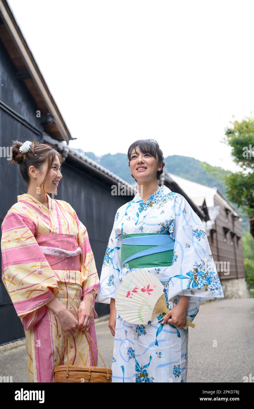 Two women in yukata walking in an old private house Stock Photo - Alamy