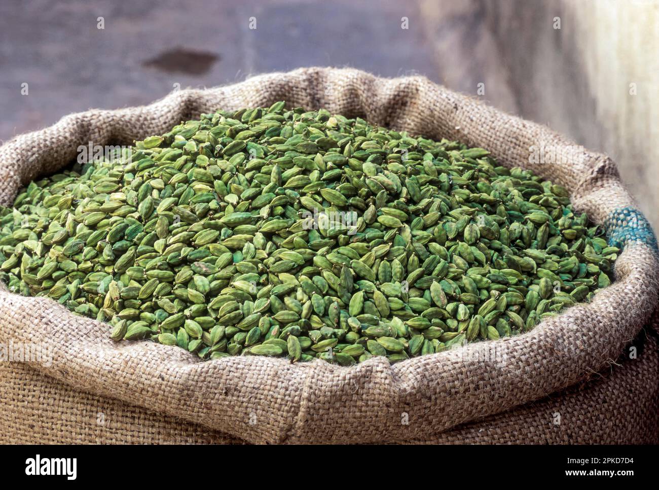A sack full of cardamom (Elettaria cardamomum) in a spice market shop ...