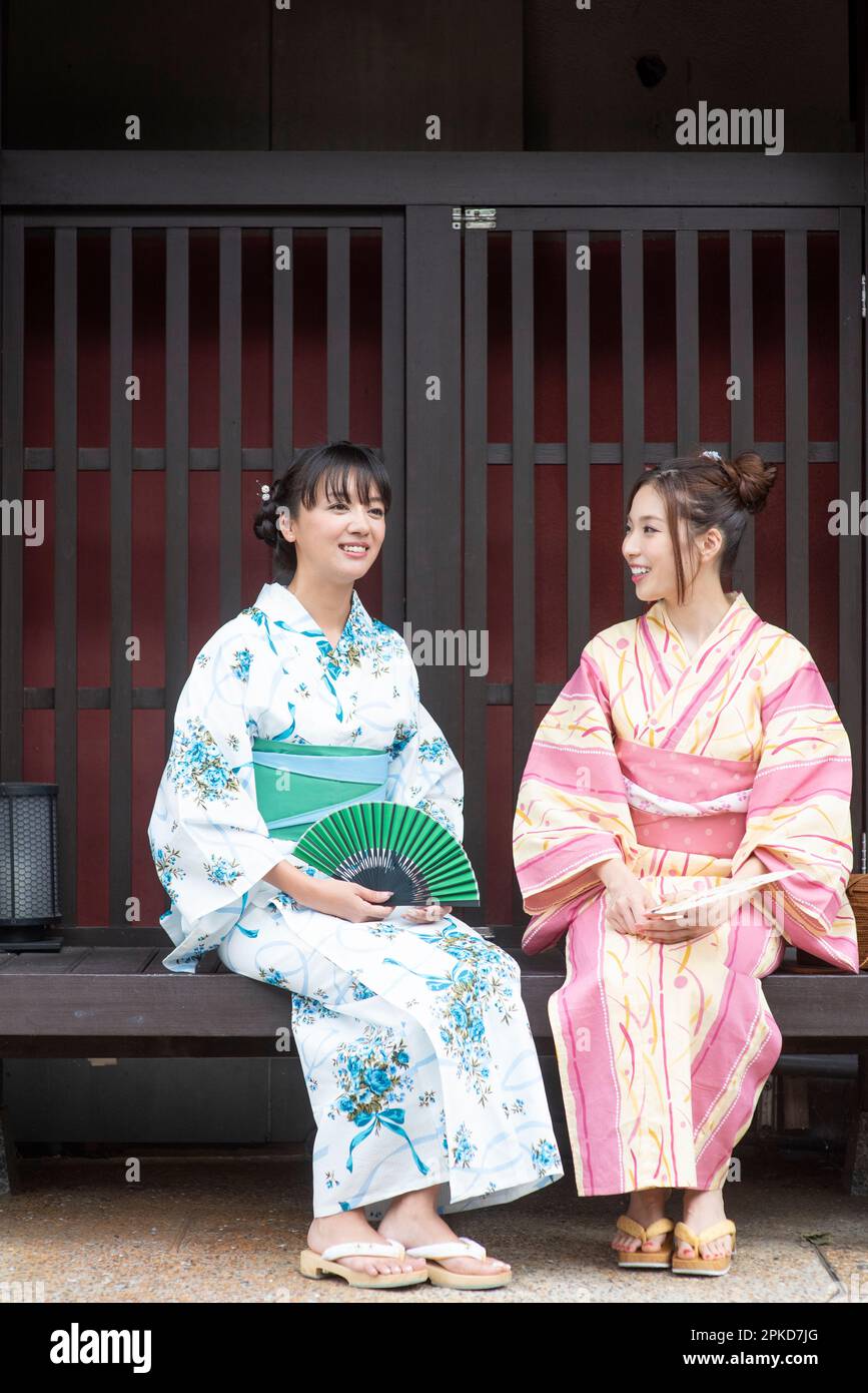 Two women in yukata chatting at an old private house Stock Photo - Alamy