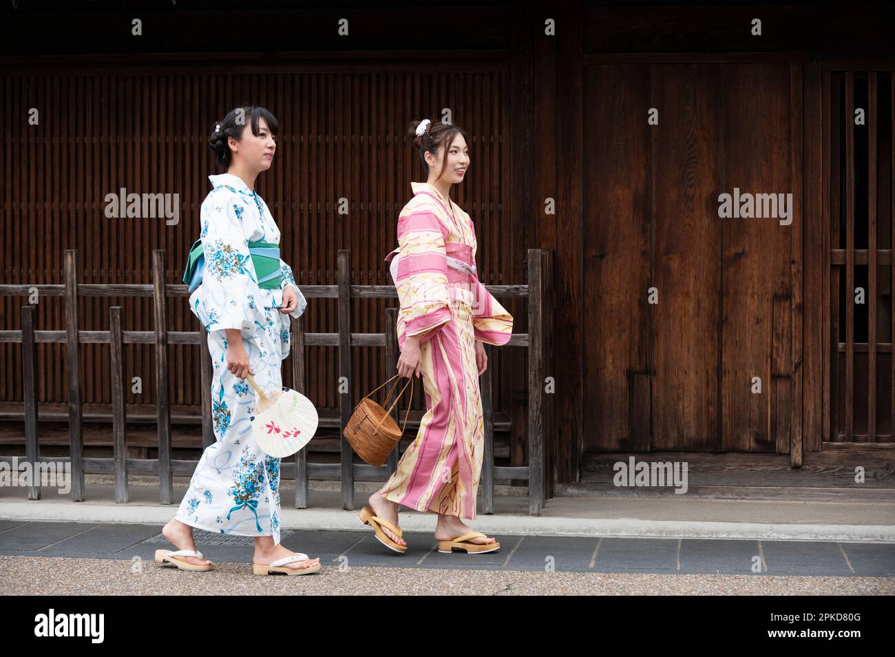 Two women in yukata strolling through an old private house Stock Photo ...