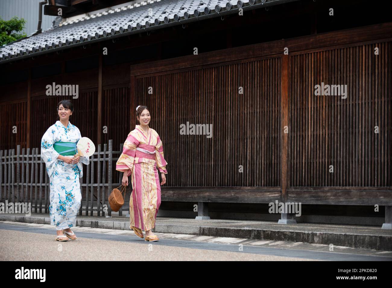 Two women in yukata strolling in an old private house Stock Photo - Alamy