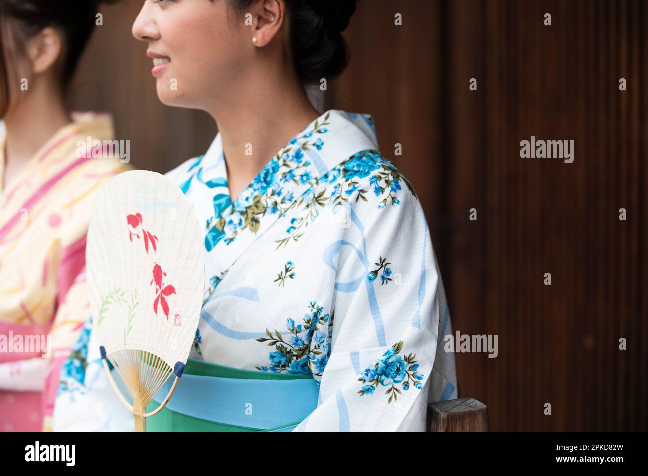 Two women in yukata with an old private house Stock Photo - Alamy