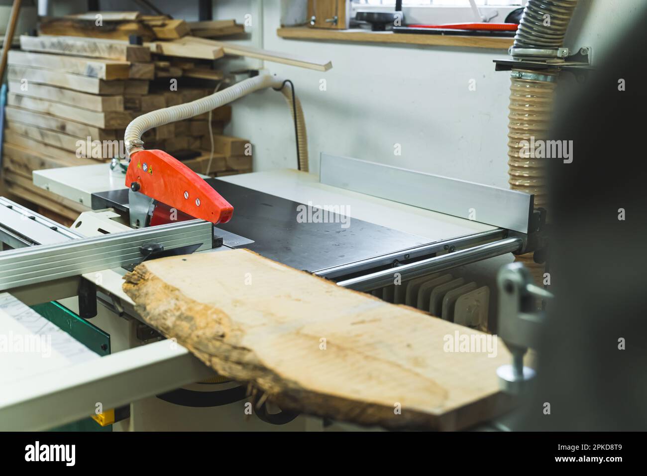 Big wood plank placed on professional table saw by expert carpenter ...