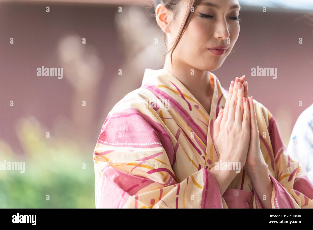Women in yukata praying in chorus at a shrine Stock Photo - Alamy