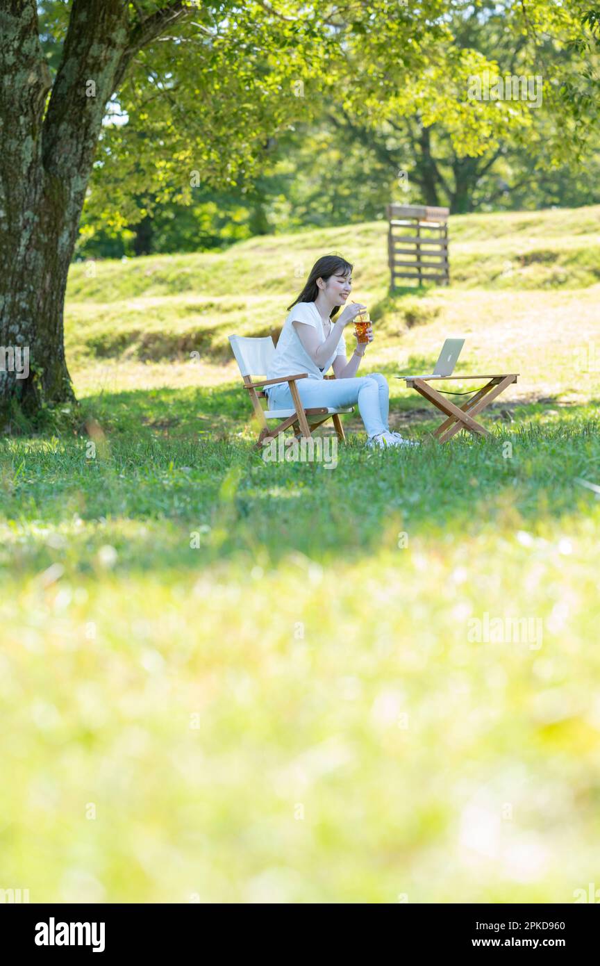 Woman working remotely at a campsite in Plateau Stock Photo - Alamy