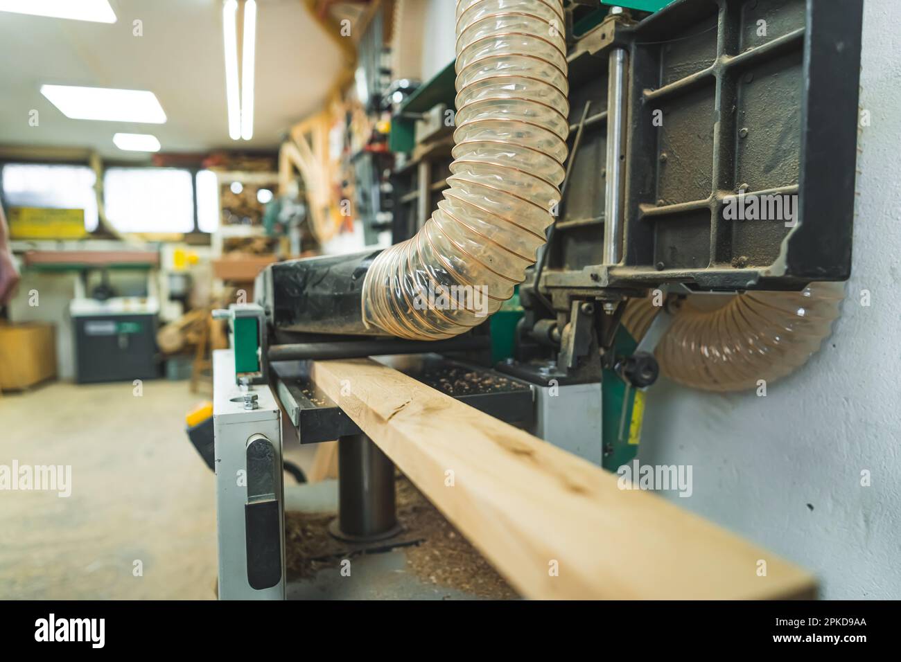 Wooden desk placed on sawdust extractor machine table in carpentry ...