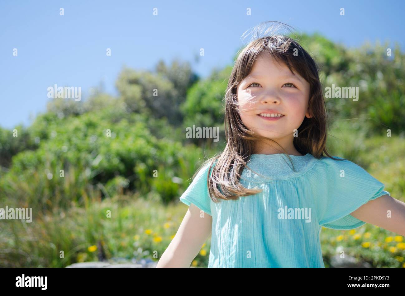 Girl looking up and smiling Stock Photo - Alamy