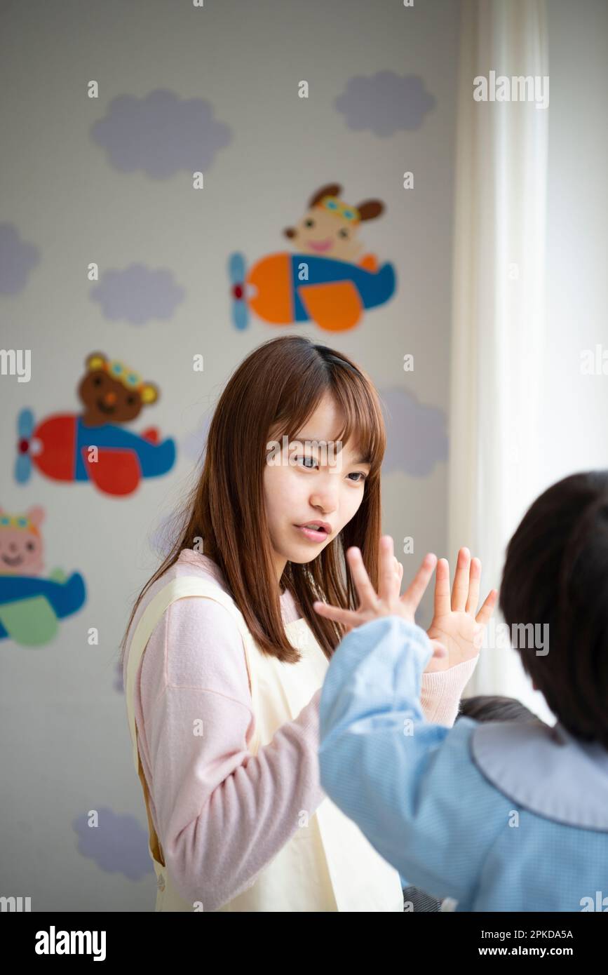Nursery school teacher talking with children Stock Photo - Alamy